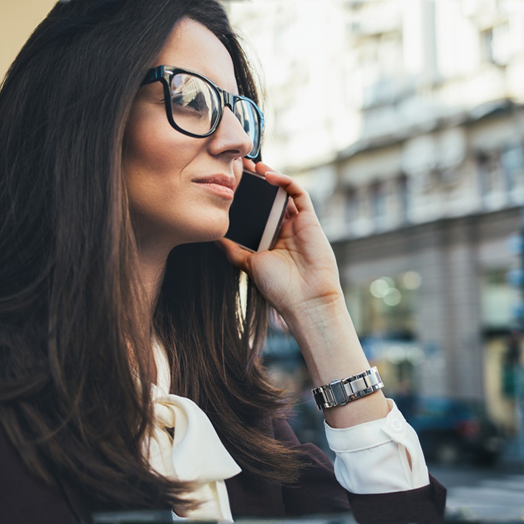 Businesswoman Making a Phone Call on the Street | Beacon Telecom